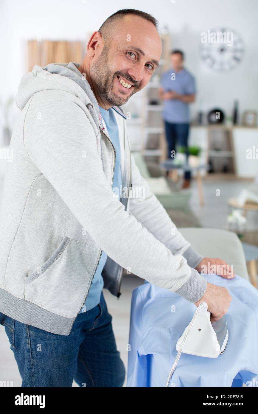 Handsome husband helping happy hi-res stock photography and images - Alamy