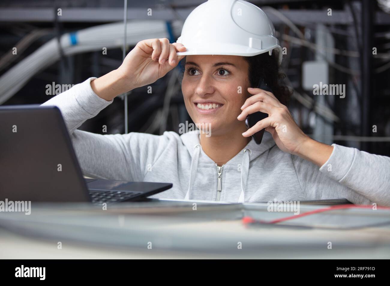 female contractor using laptop in roofspace Stock Photo - Alamy