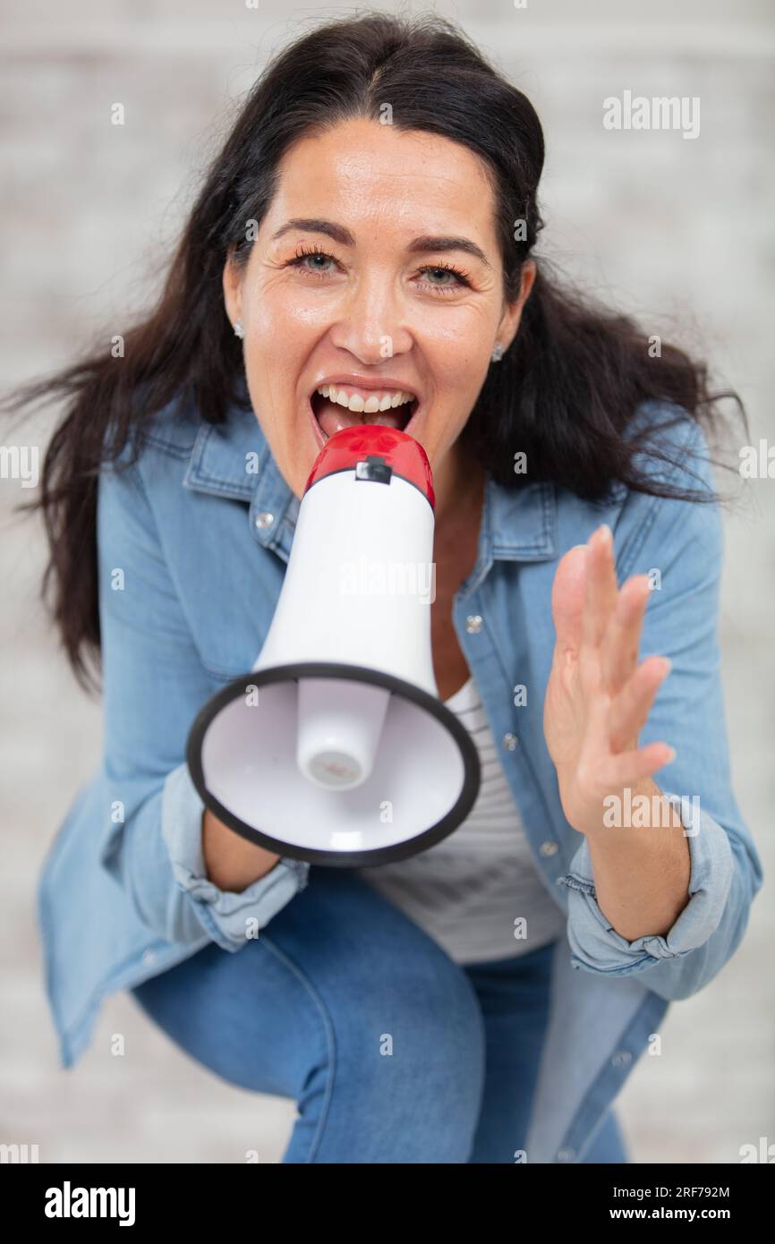 energetic woman shouting into a megaphone Stock Photo - Alamy