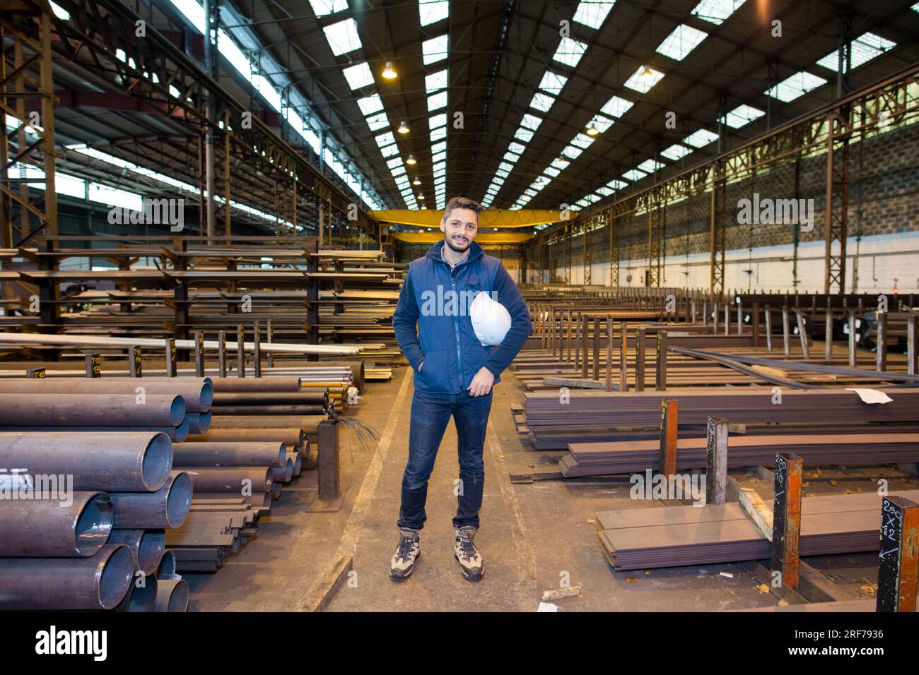 a steel pipes factory worker Stock Photo - Alamy
