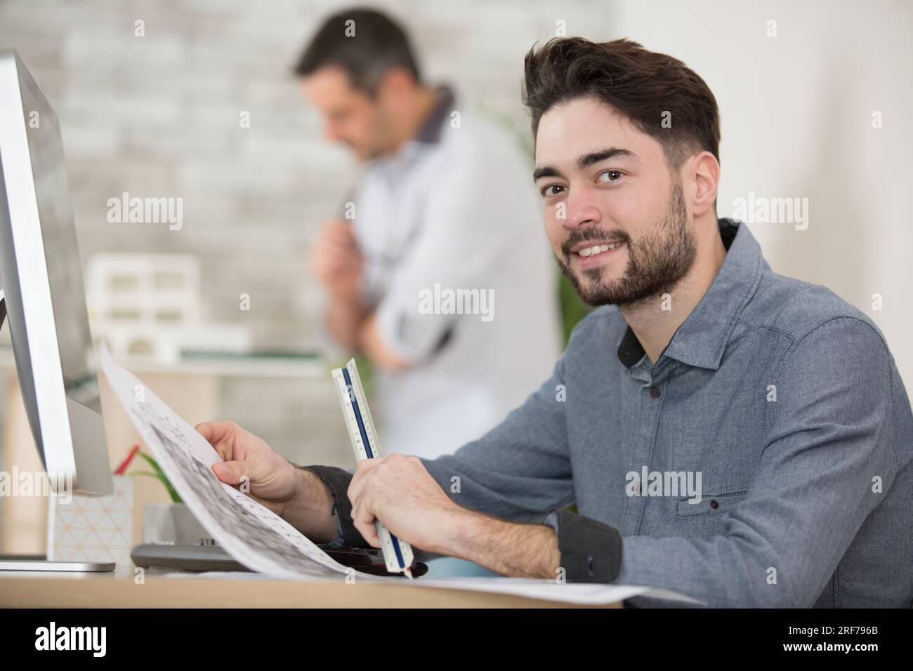 portrait of engineer studying layout plan on the office Stock Photo - Alamy