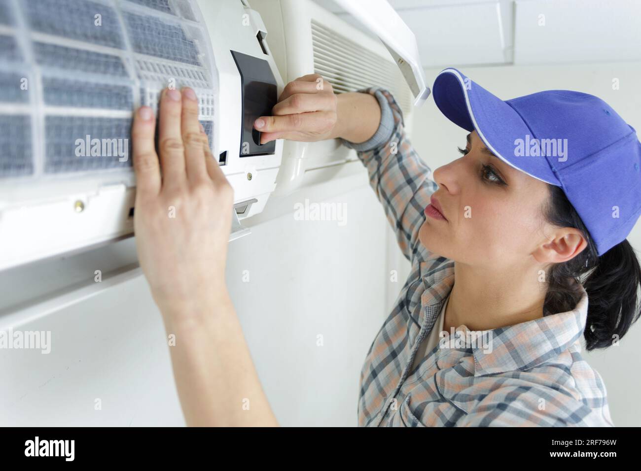 female technician working on air conditioning unit Stock Photo - Alamy
