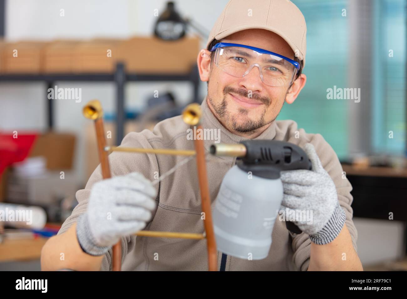 young plumber fixing copper pipe Stock Photo - Alamy