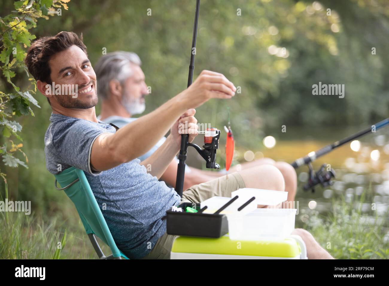 portrait of two male friends fishing Stock Photo - Alamy