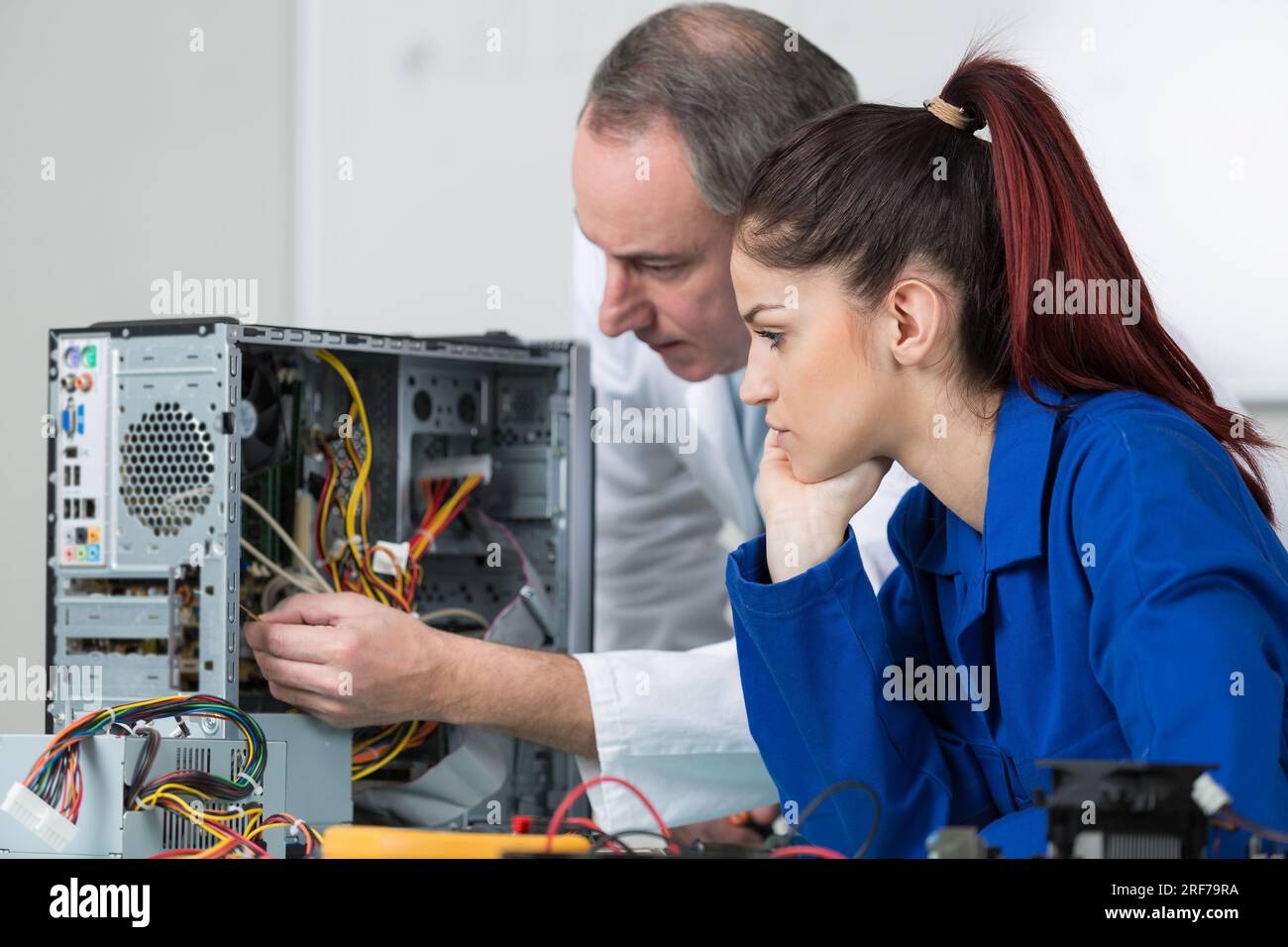 young woman fix pc component with teacher Stock Photo - Alamy