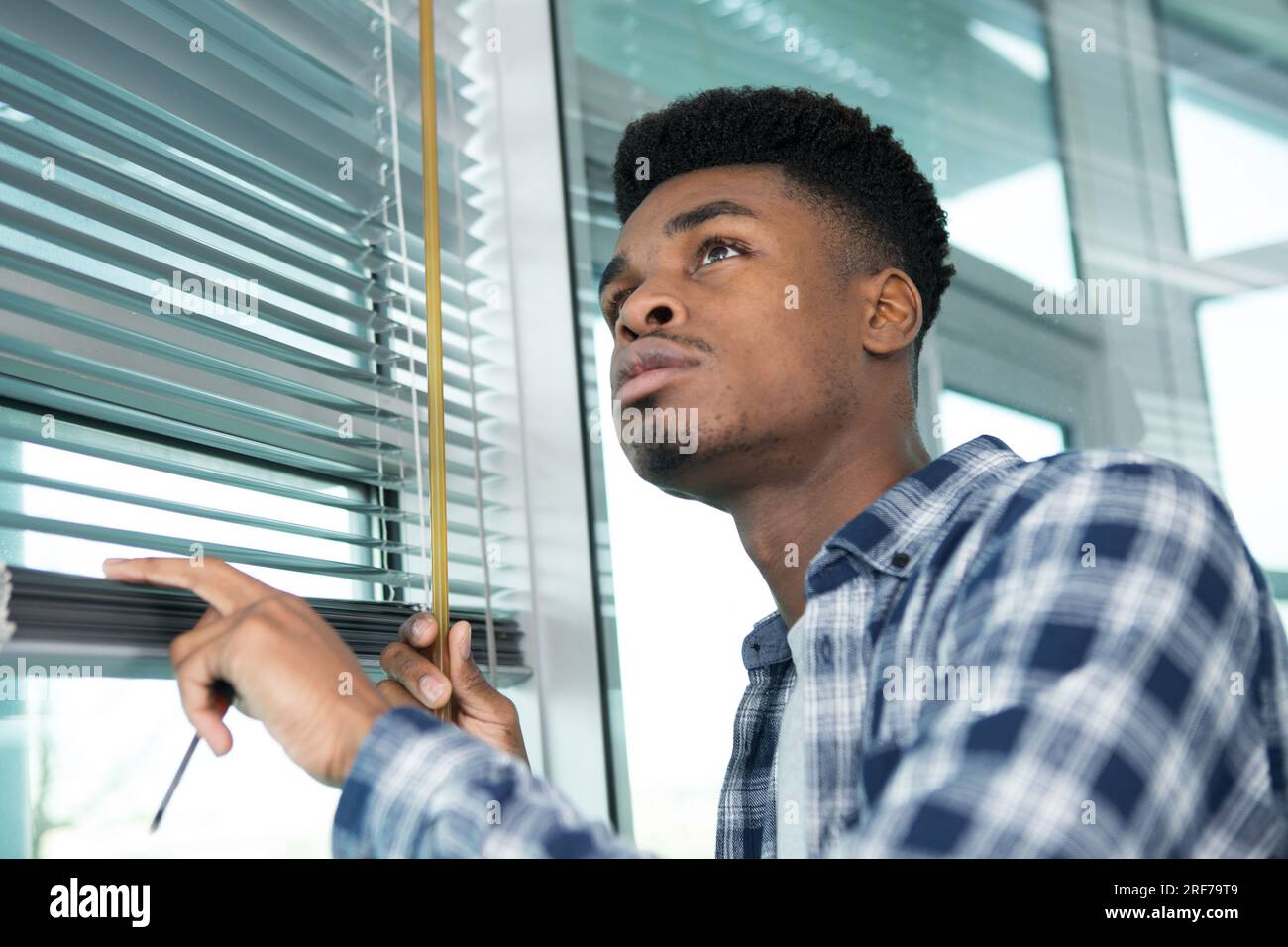 young man measuring a window for blind installation Stock Photo - Alamy