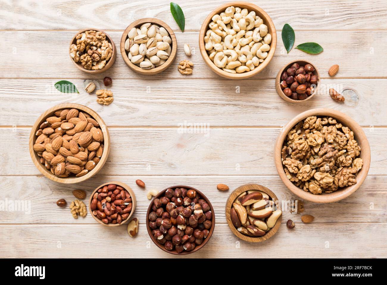 mixed nuts in wooden bowl. Mix of various nuts on colored background ...
