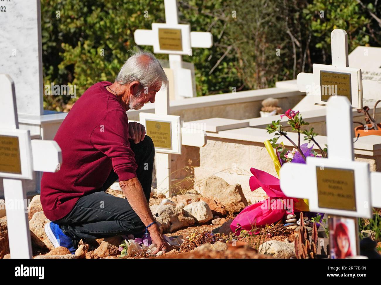 David Hunter lays flowers at the grave of his wife Janice Hunter at a ...