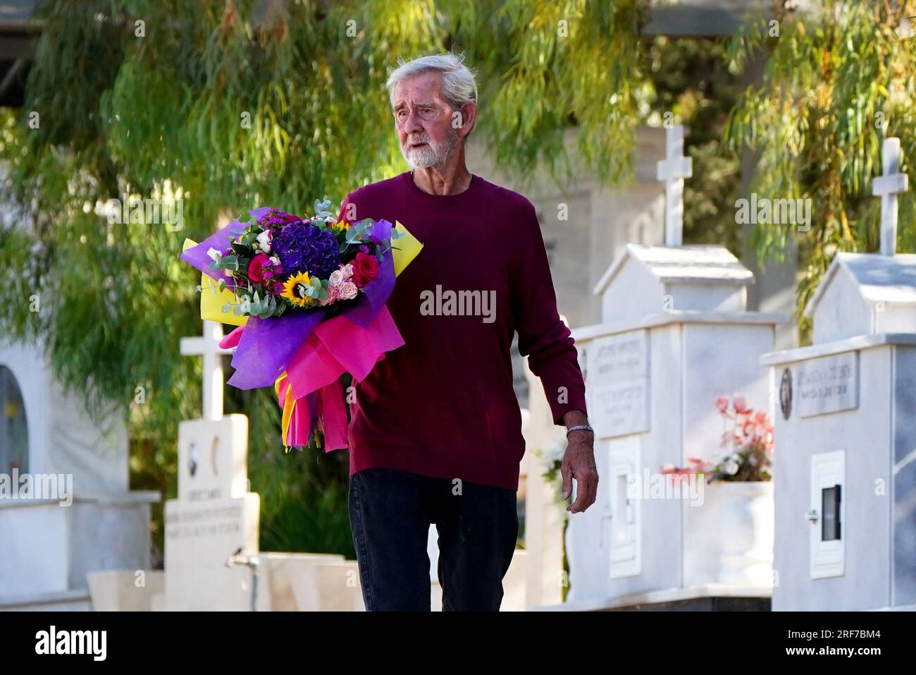 David Hunter lays flowers at the grave of his wife Janice Hunter at a ...
