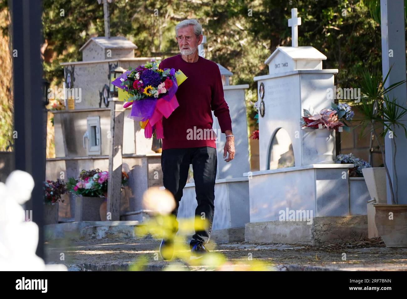 David Hunter lays flowers at the grave of his wife Janice Hunter at a ...