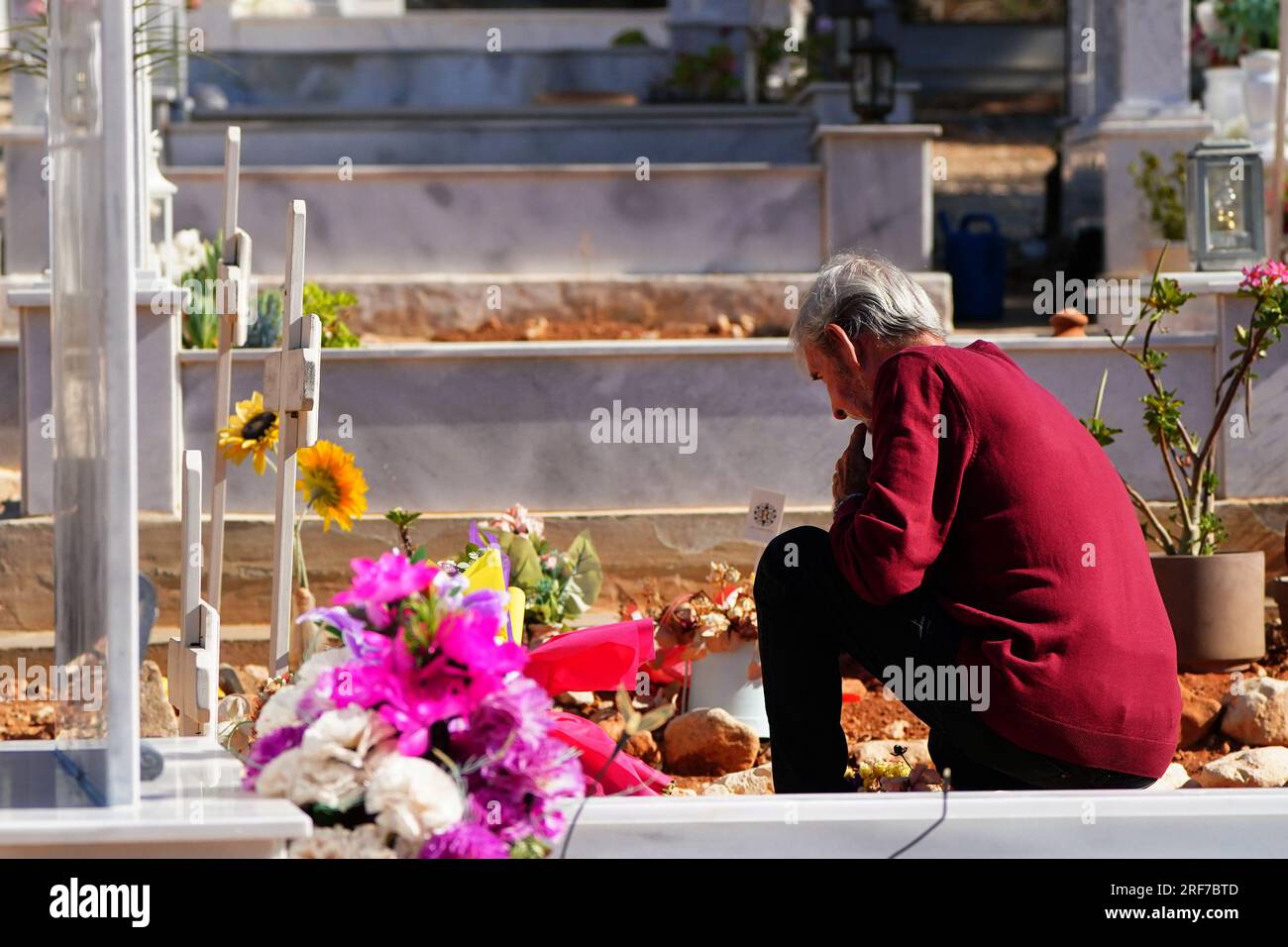 David Hunter lays flowers at the grave of his wife Janice Hunter at a ...