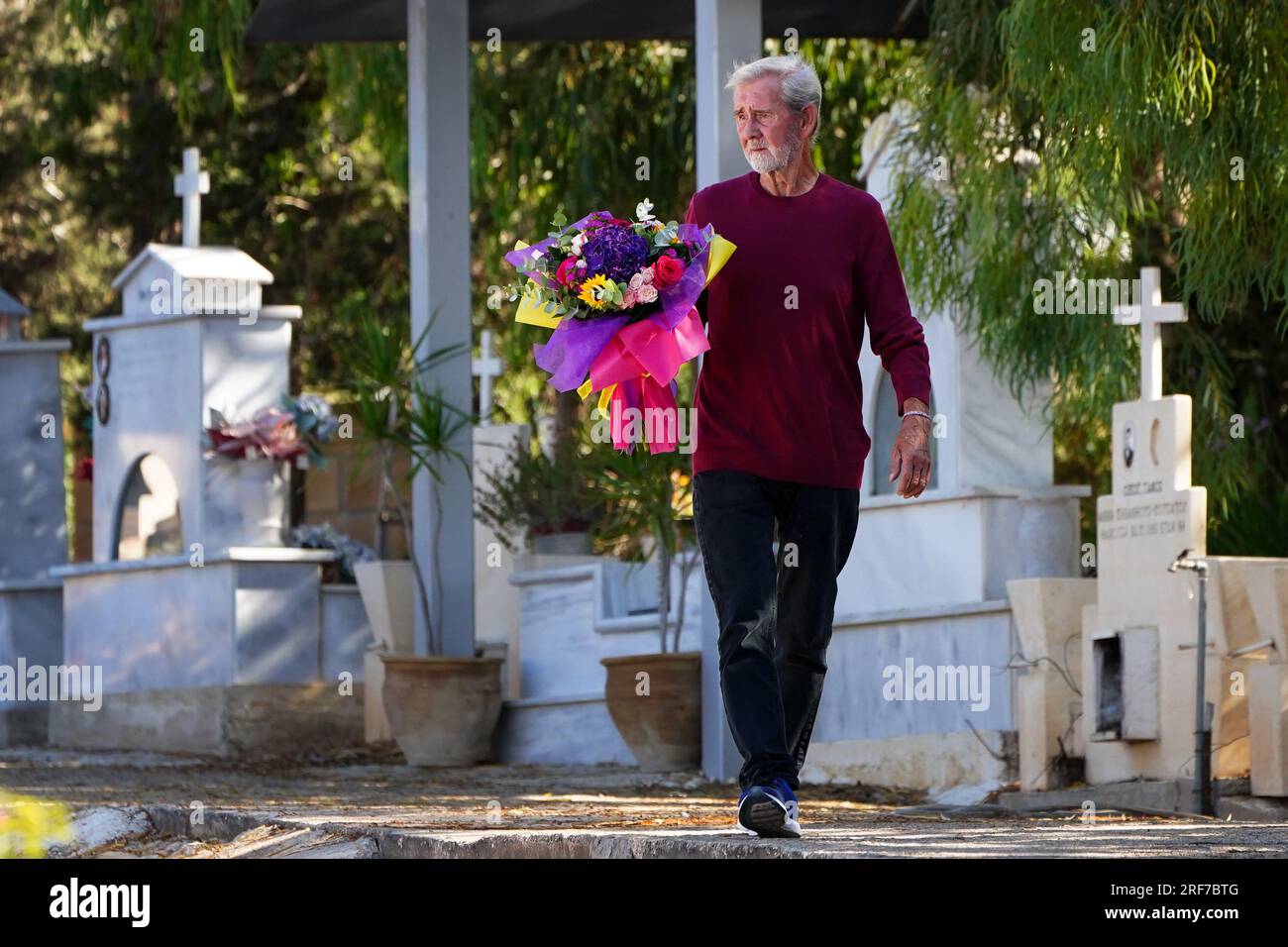 David Hunter lays flowers at the grave of his wife Janice Hunter at a ...