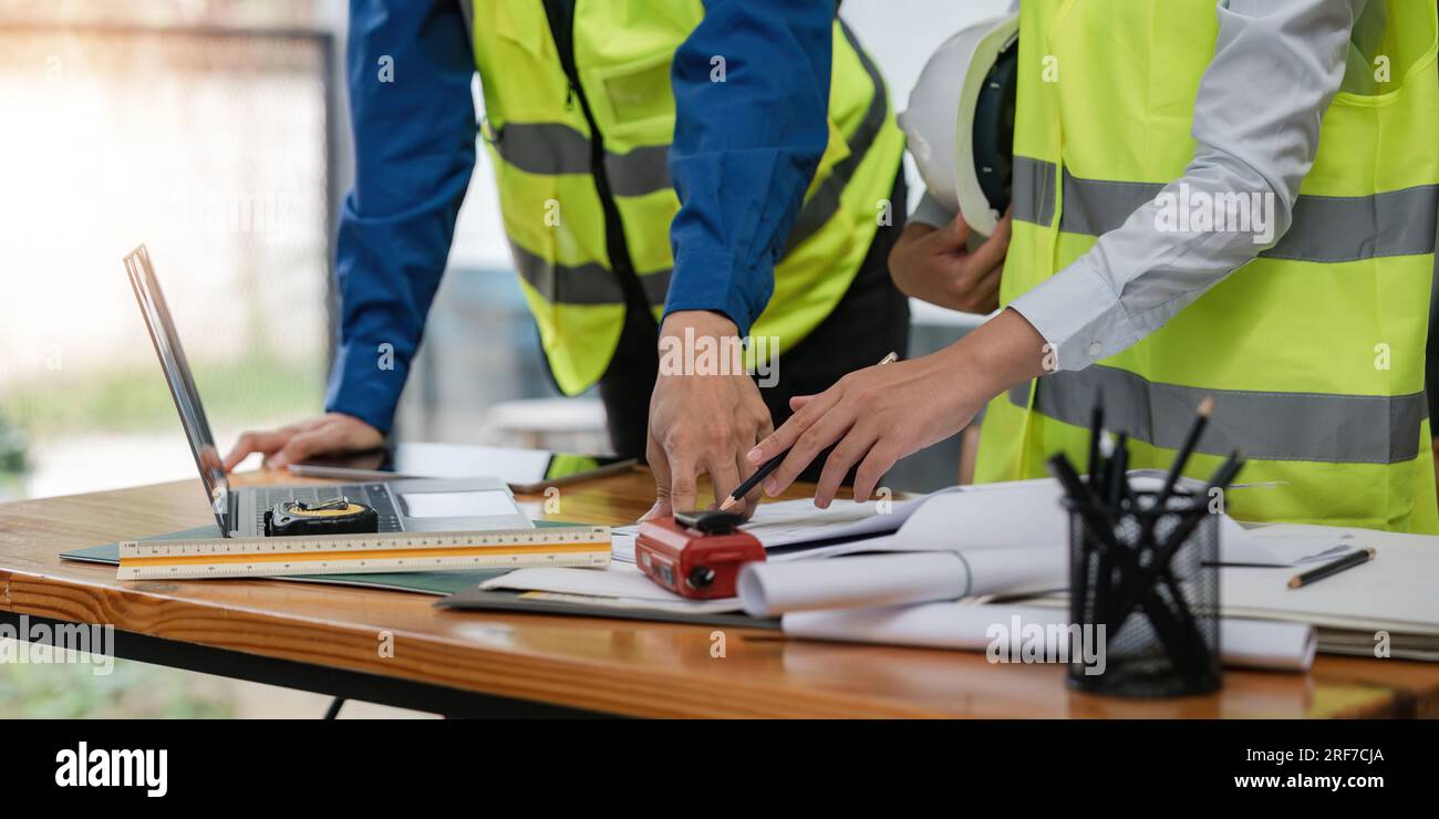 Two engineer working in office with blueprints, inspection in workplace ...