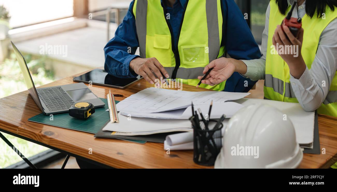 Two engineer working in office with blueprints, inspection in workplace ...