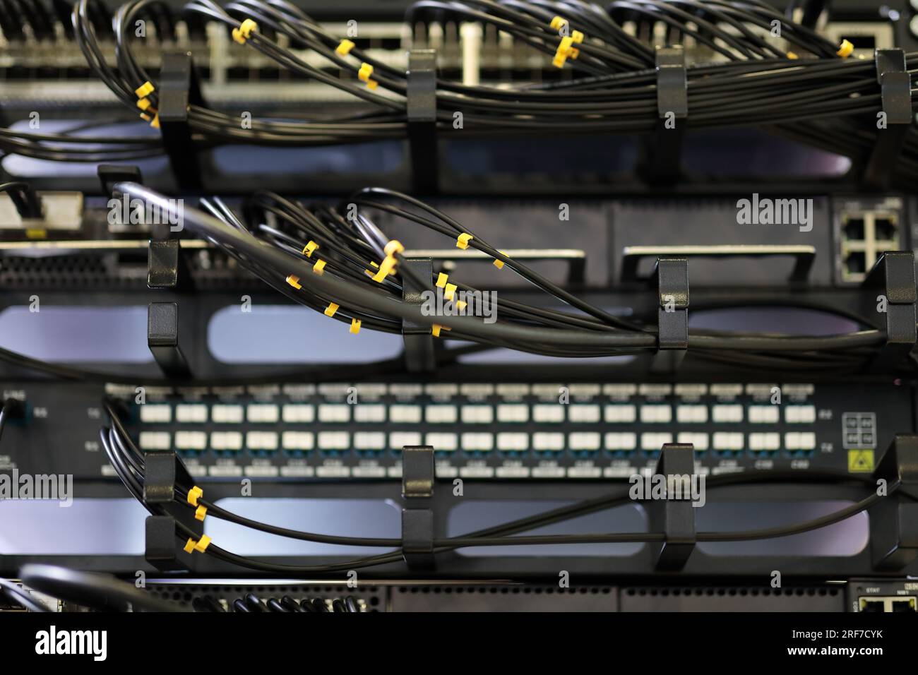 Server rack with metal horizontal cable managers close up. Selective ...