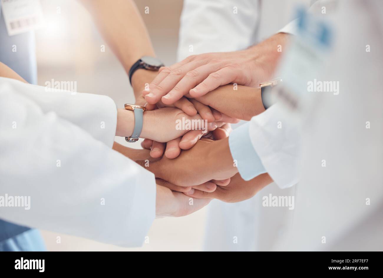 Hands together, team and collaboration with doctors and support ...