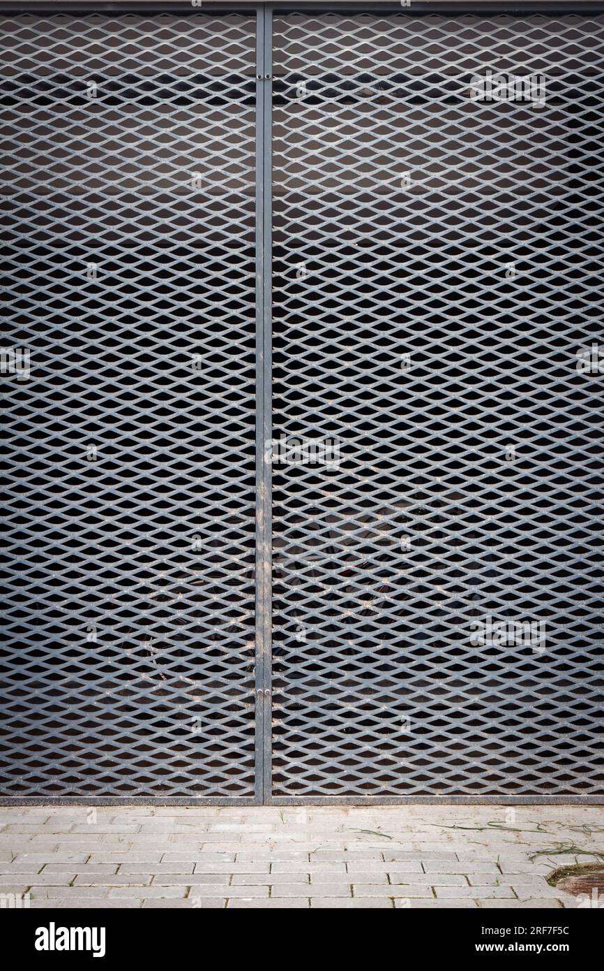 Iron grid wall and a sidewalk. Architecture detail background Stock ...