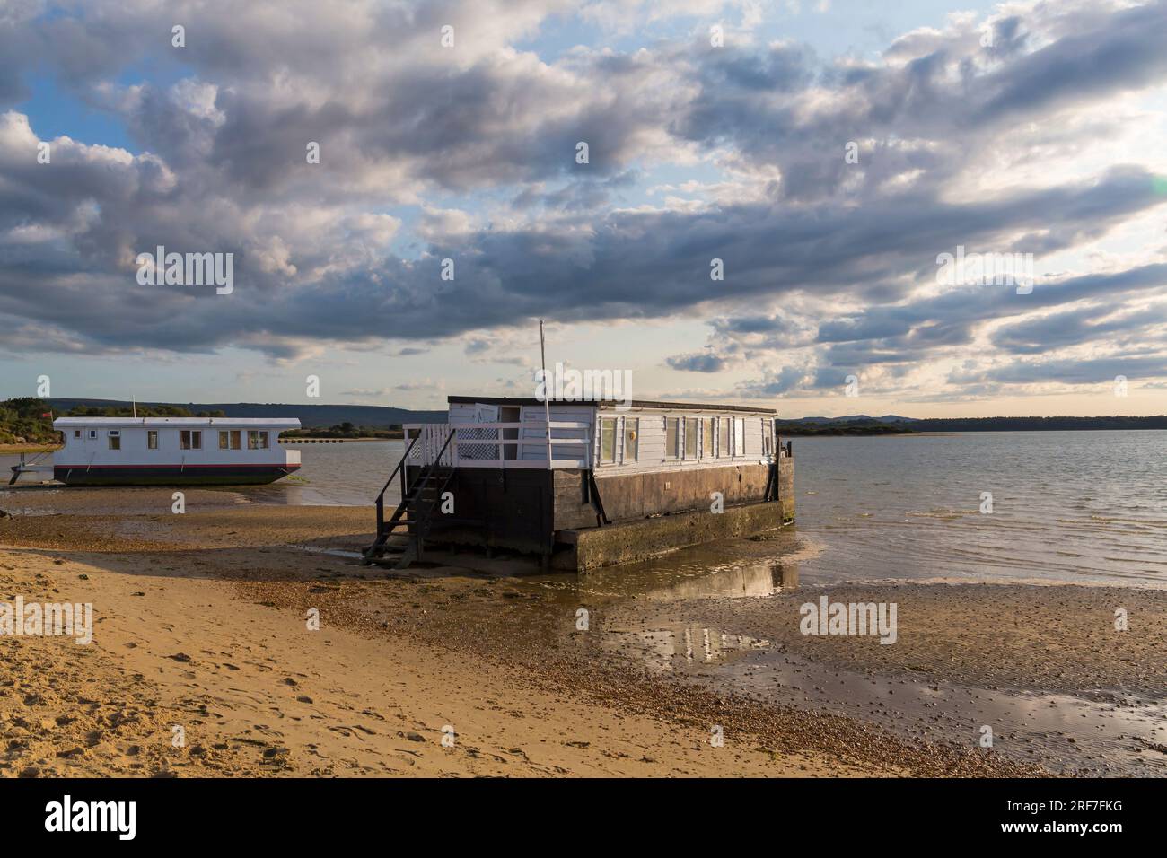 Two houseboats, house boats at Studland Bay, Dorset UK in July at dusk with beautiful lighting ...