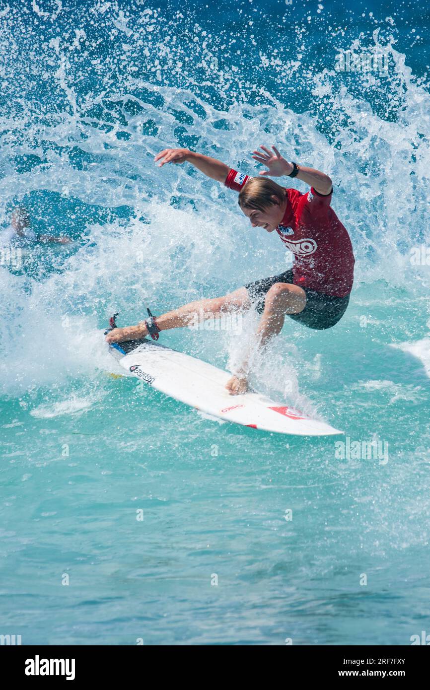 Teenage boys and girls surfing in a junior competition in Newcastle NSW ...