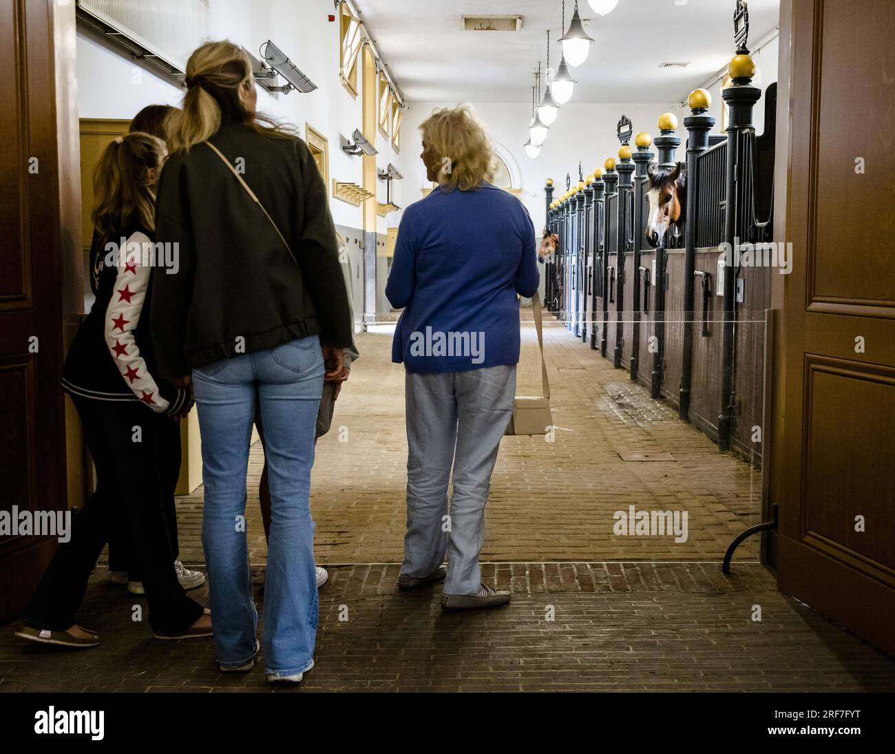 THE HAGUE - Visitors walk through the Royal Stables at Noordeinde Palace. The palace and the ...