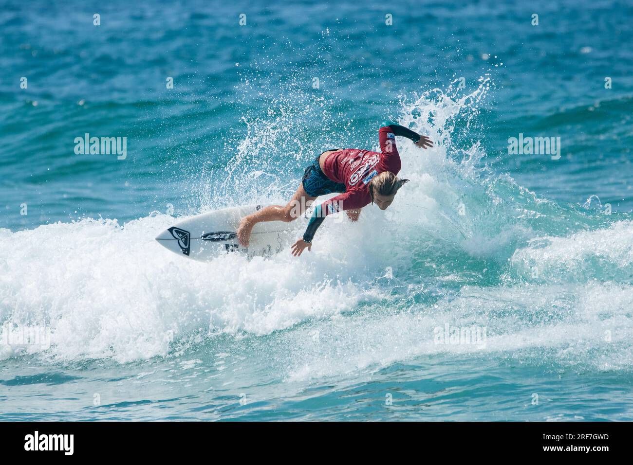 Teenage boys and girls surfing in a junior competition in Newcastle NSW ...