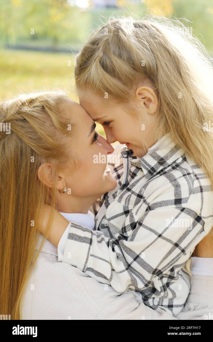 Mother And Daughter Spend Time Together In The Autumn Park Mother And
