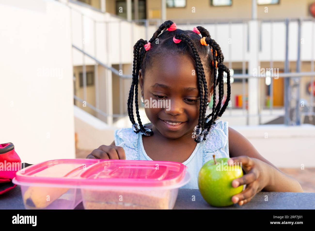 African american schoolgirl at table and having healthy lunch eating ...