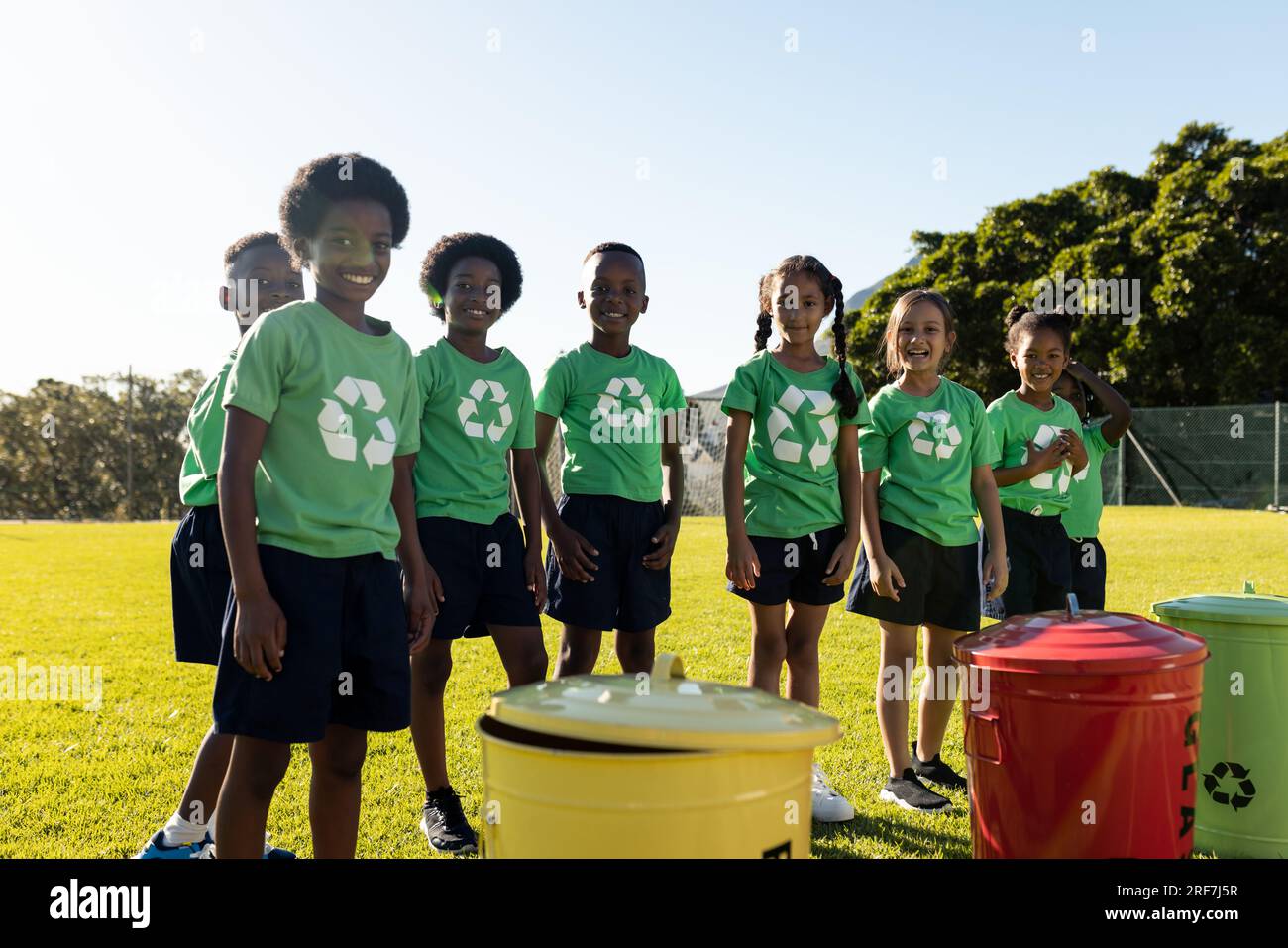 Portrait of happy diverse children collecting recycling smiling in ...