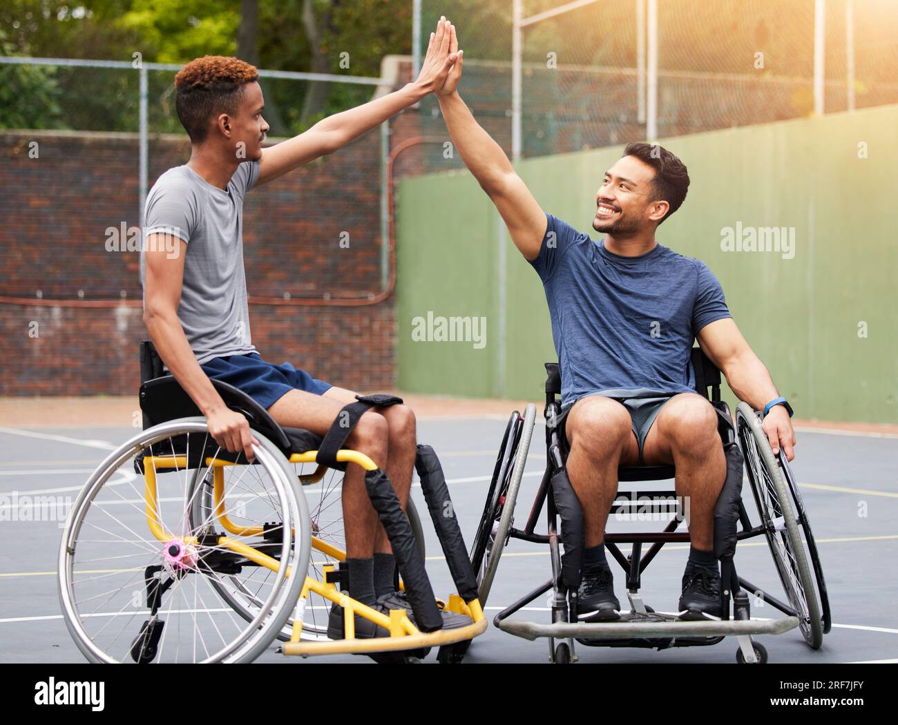 Sports, wheelchair basketball court and happy people high five ...