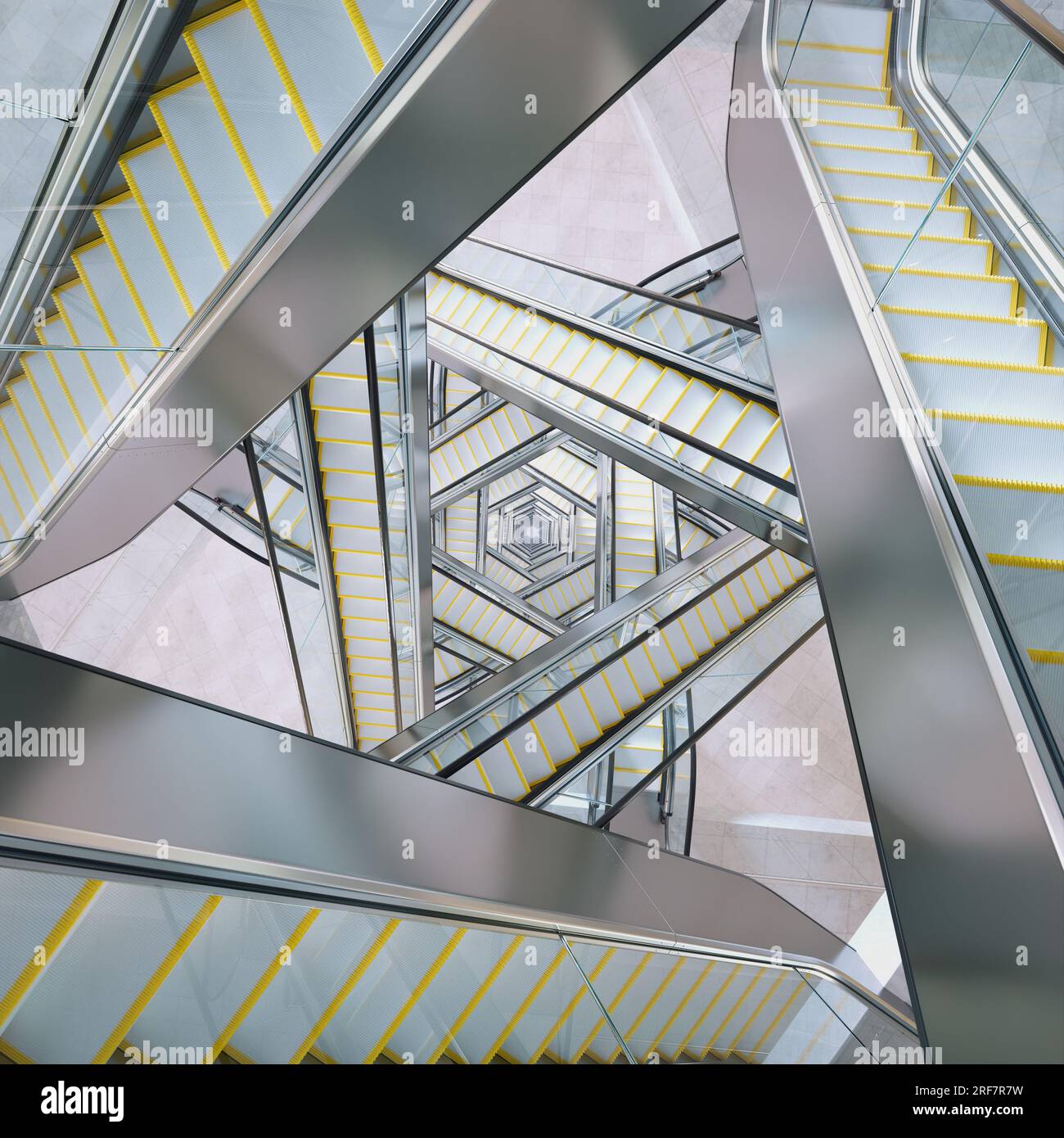 Puzzling labyrinth of escalators made of glass and steel. Complicated ...