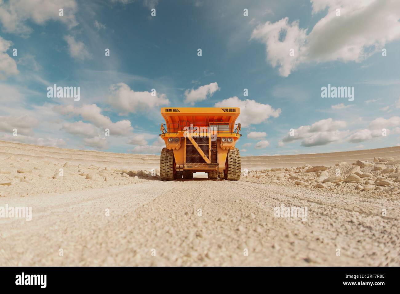 A giant, yellow dump truck transporting a heavy load through a dusty ...