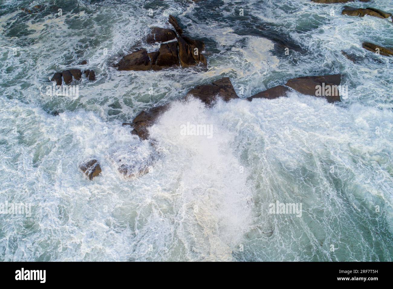 Aerial view of the sea waves breaking on a rocky shore Stock Photo - Alamy