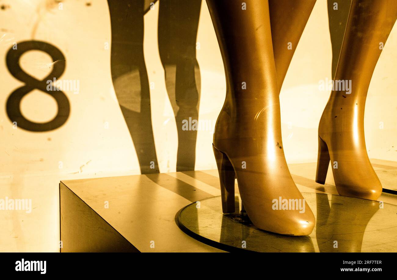 Mannequin feet in store front window Stock Photo - Alamy