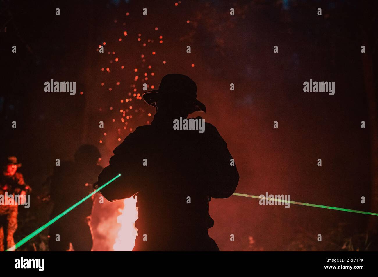 Soldiers squad in action on night mission using laser sight beam lights ...