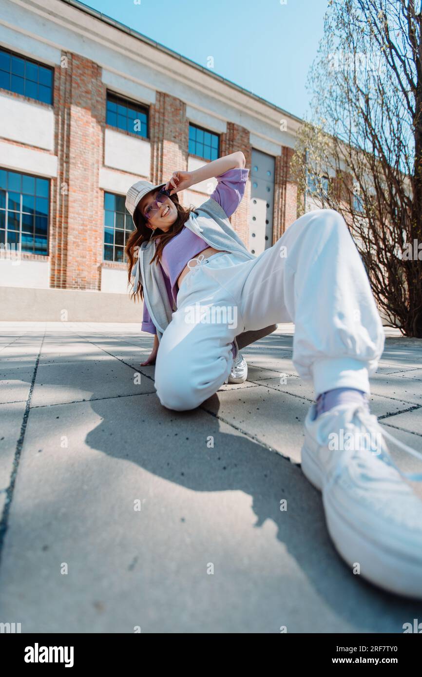 Vertical view of girl performing hip hop dance style having fun ...