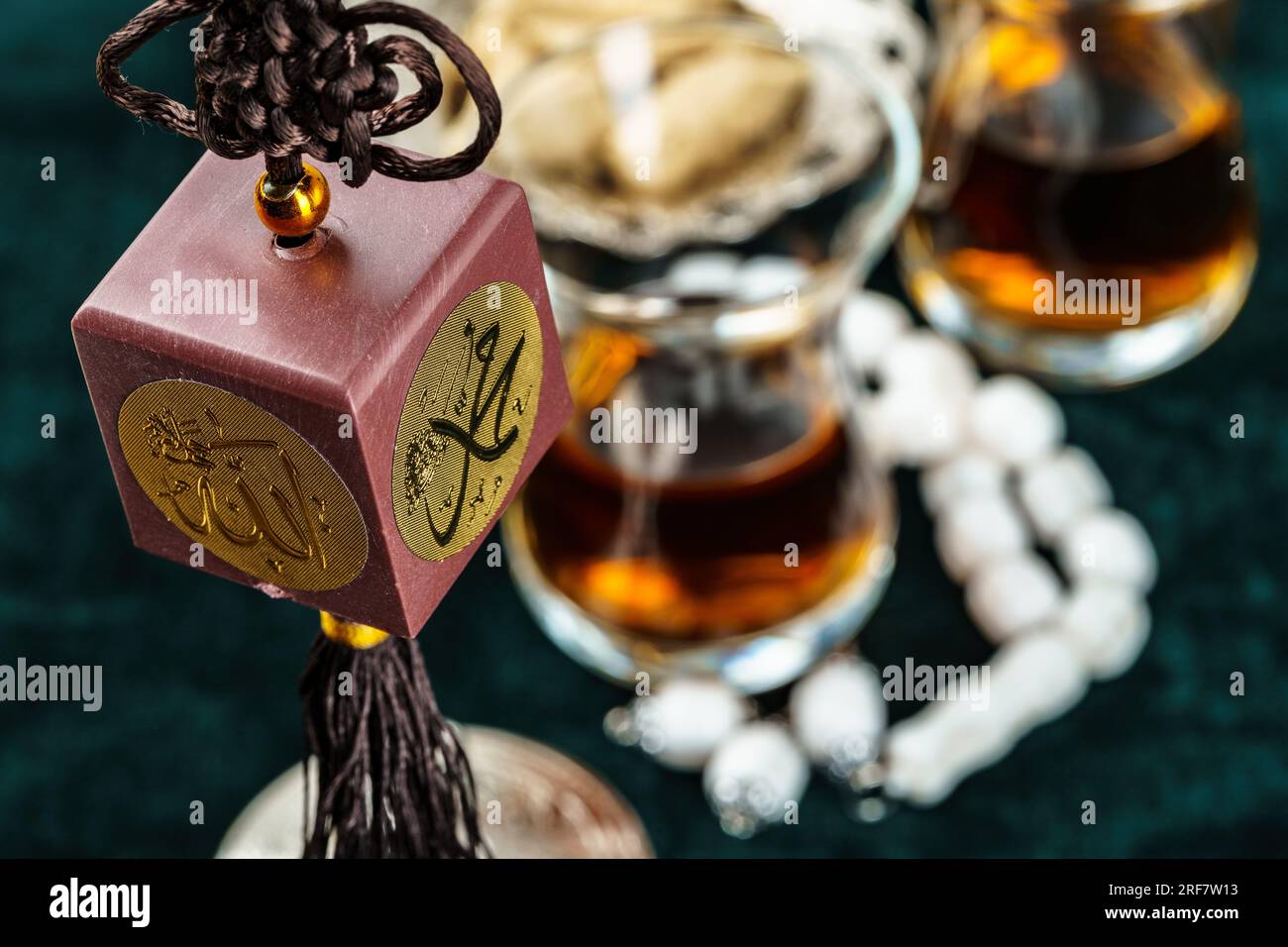 Muslim amulet of bordeux color on rope Stock Photo - Alamy