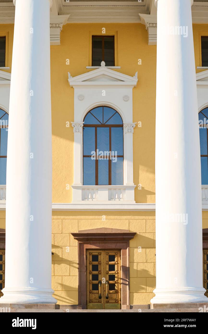 Section of cultural institution building with two white plaster columns ...