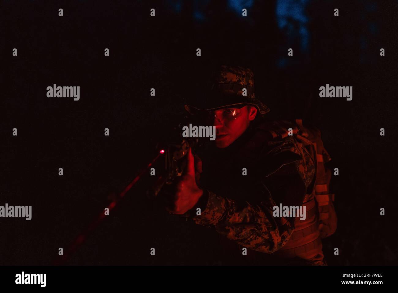 Soldiers squad in action on night mission using laser sight beam lights ...