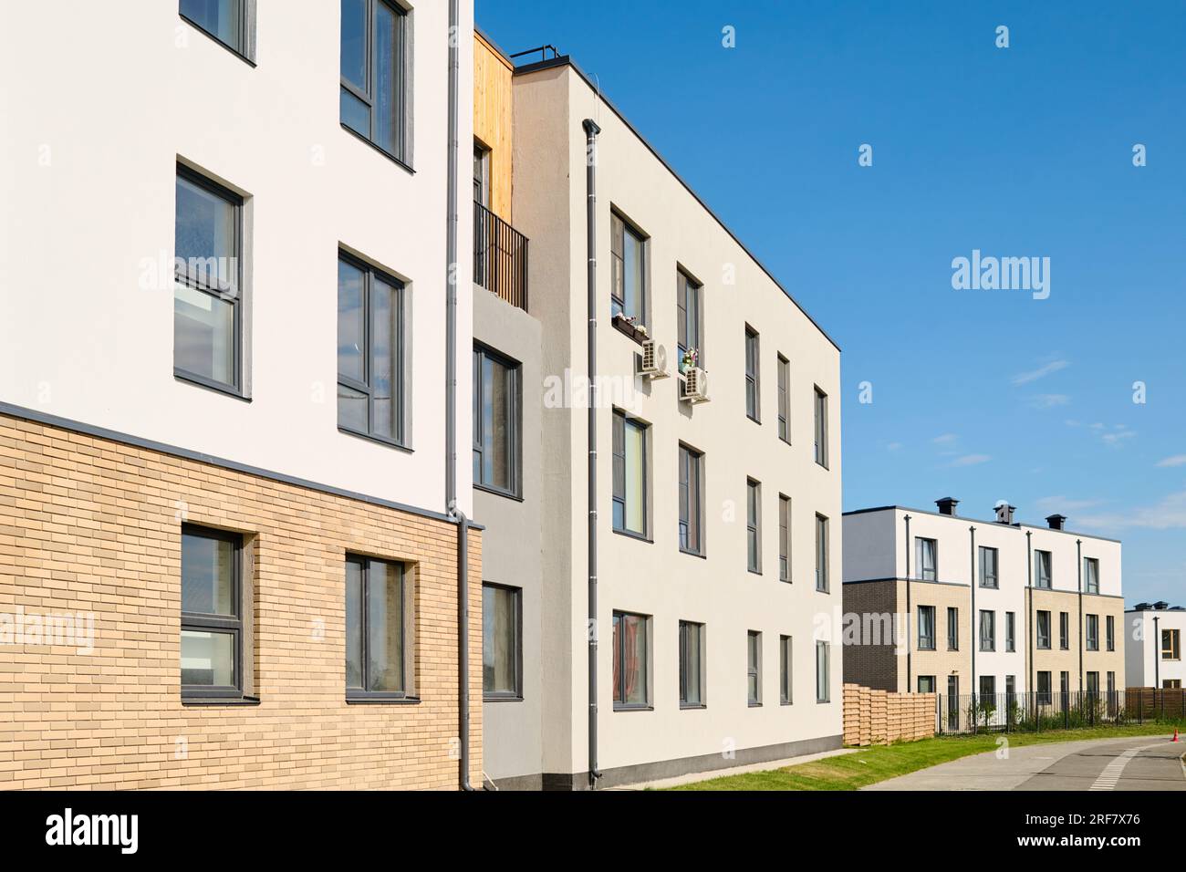 Perspective of long white three storey block of flats with windows ...