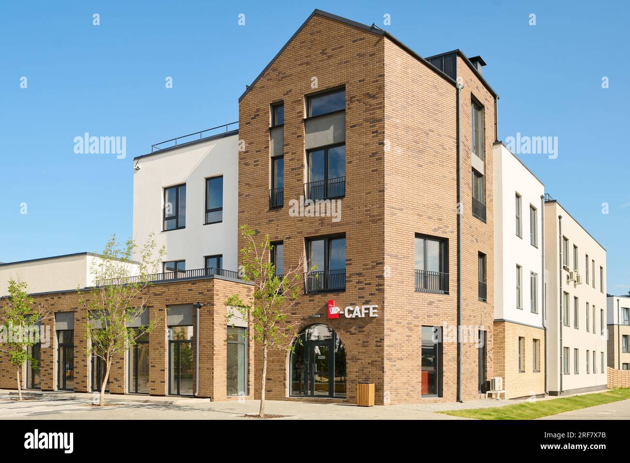 Part of large street with corner of long three storey brick block of ...