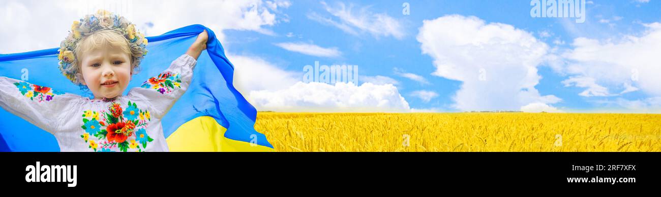 flag of Ukraine is on the shoulders of a little Ukrainian girl. Happy ...