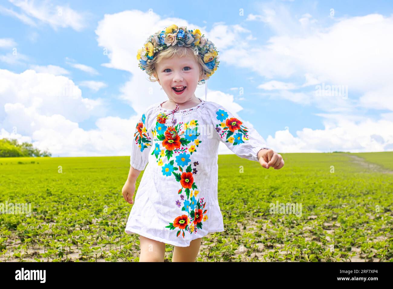 flag of Ukraine is on the shoulders of a little Ukrainian girl. Happy ...