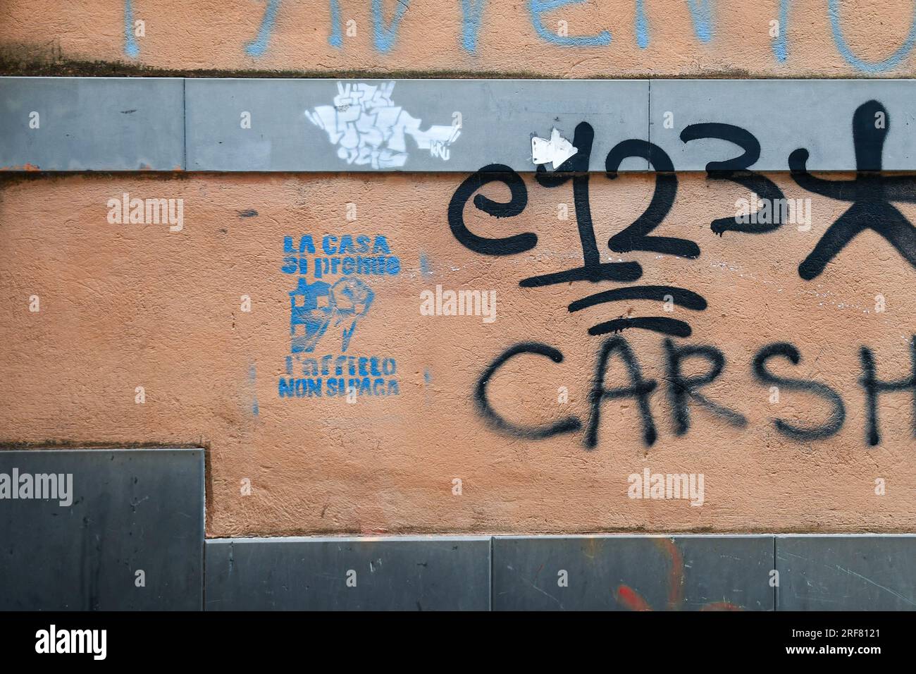 Graffiti and anarchist stencil praising squatting on a wall of the ...