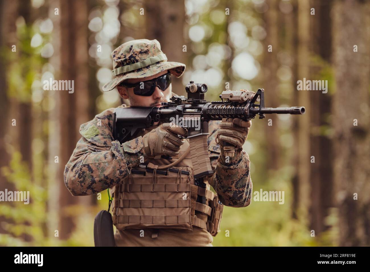 A modern warfare soldier on war duty in dense and dangerous forest ...