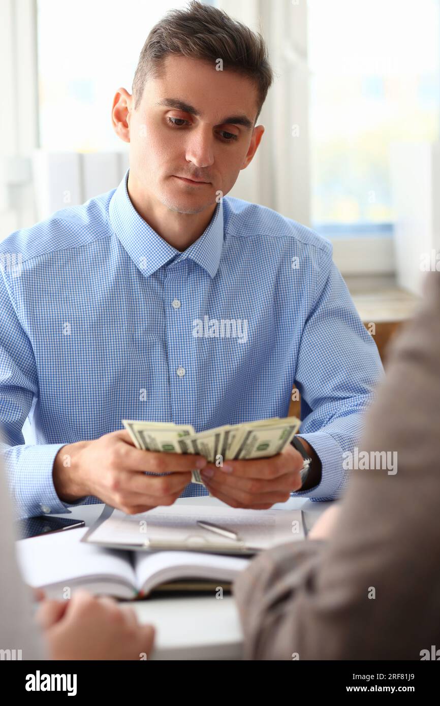 Team of business people counts earned money and successful deal ...