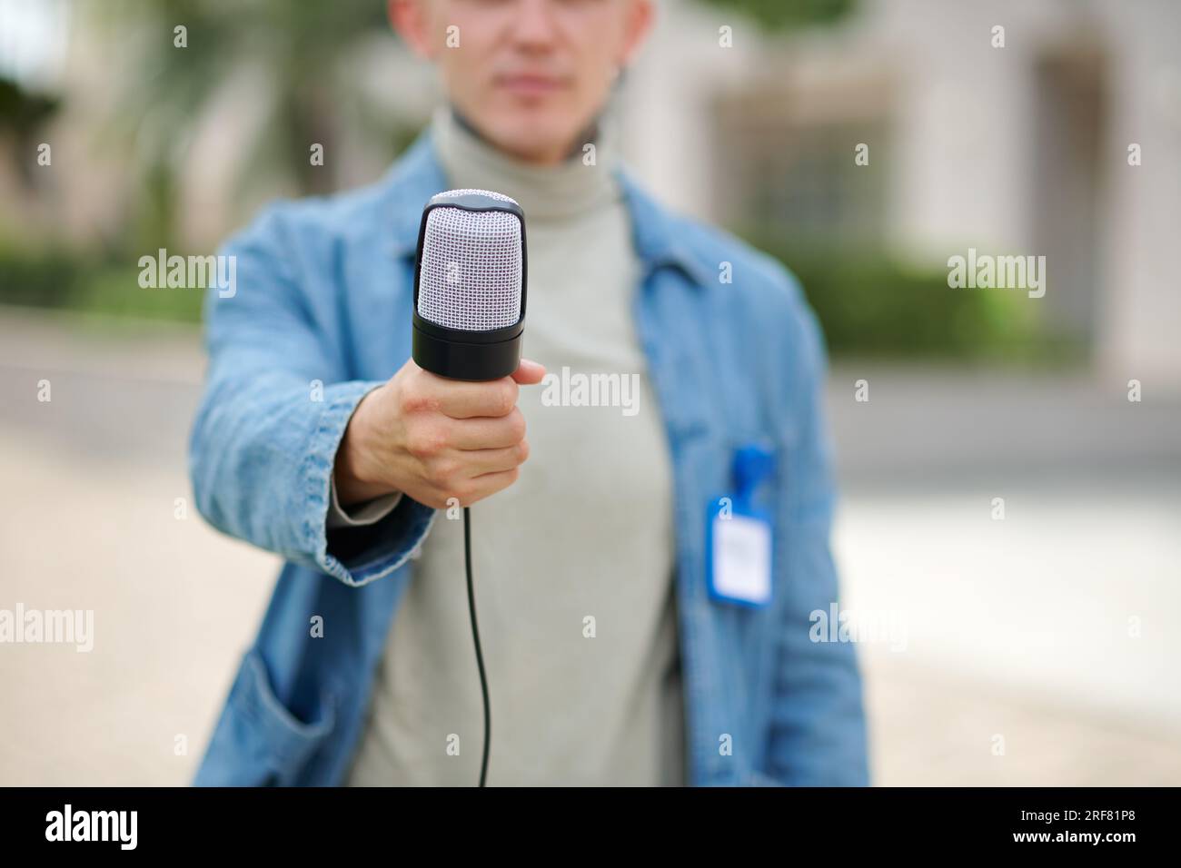 Journalist outstretching hand with microphone and asking question Stock ...