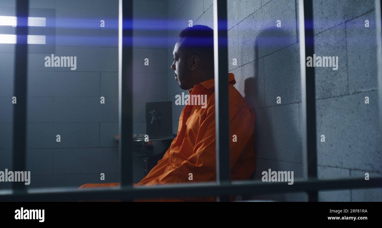 Man sits in jail cell hi-res stock photography and images - Alamy