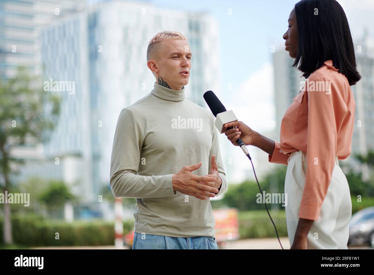 Serious man giving interview to local channel journalist Stock Photo ...
