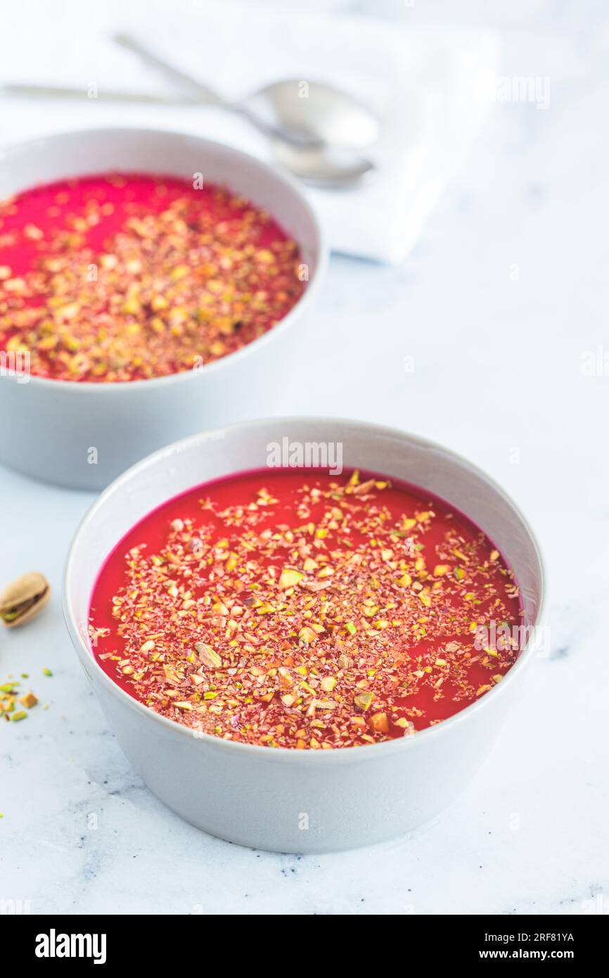 Malabi traditional Arabic dessert. Milk pudding with pink syrup and ...