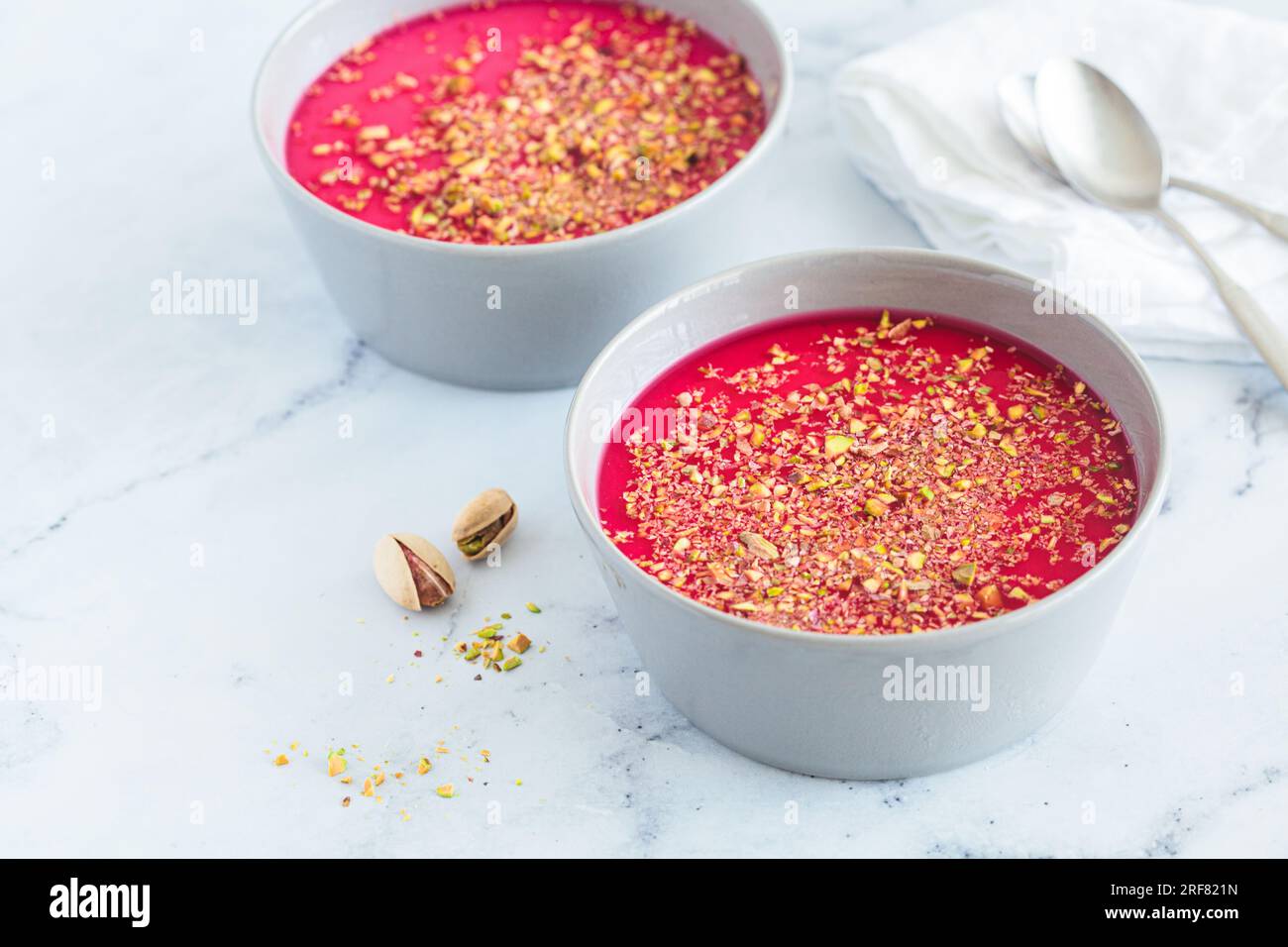 Malabi traditional Arabic dessert. Milk pudding with pink syrup and ...